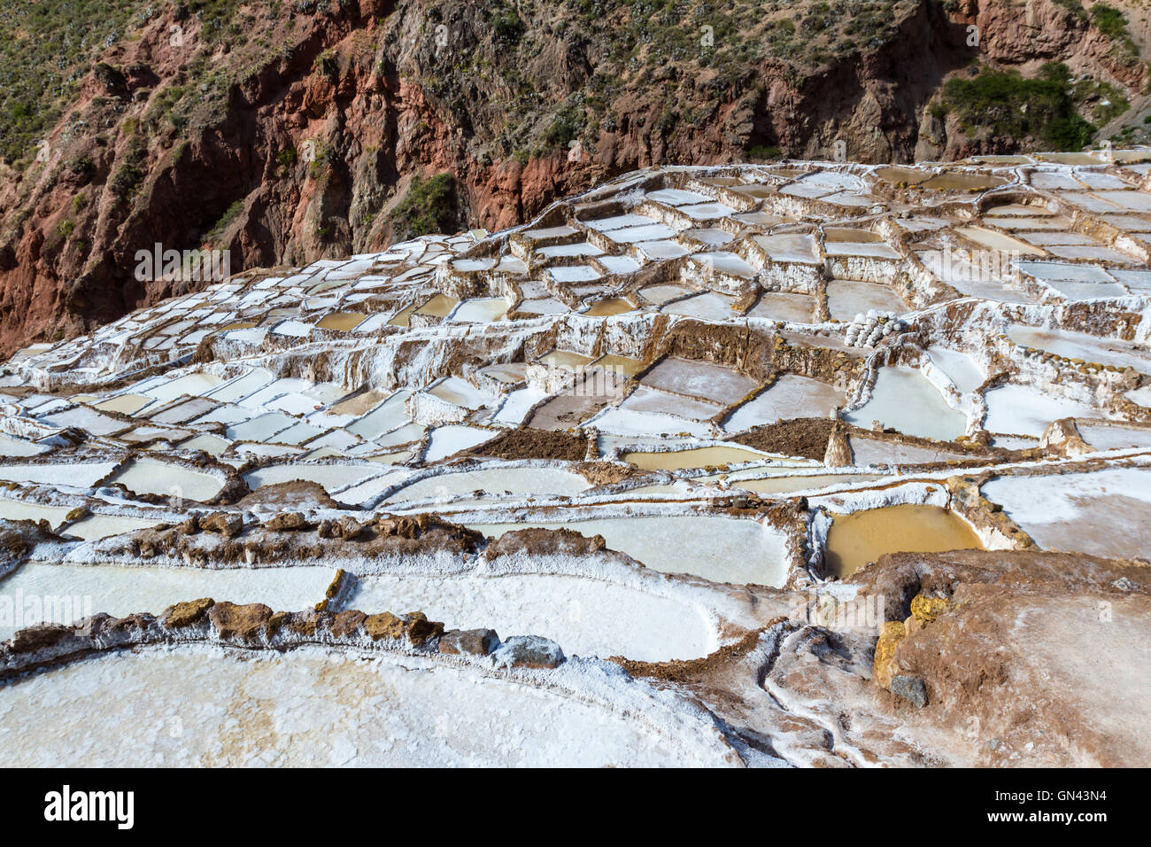 Salt ponds in Maras Peru covering a hillside with rich minerals and a ...