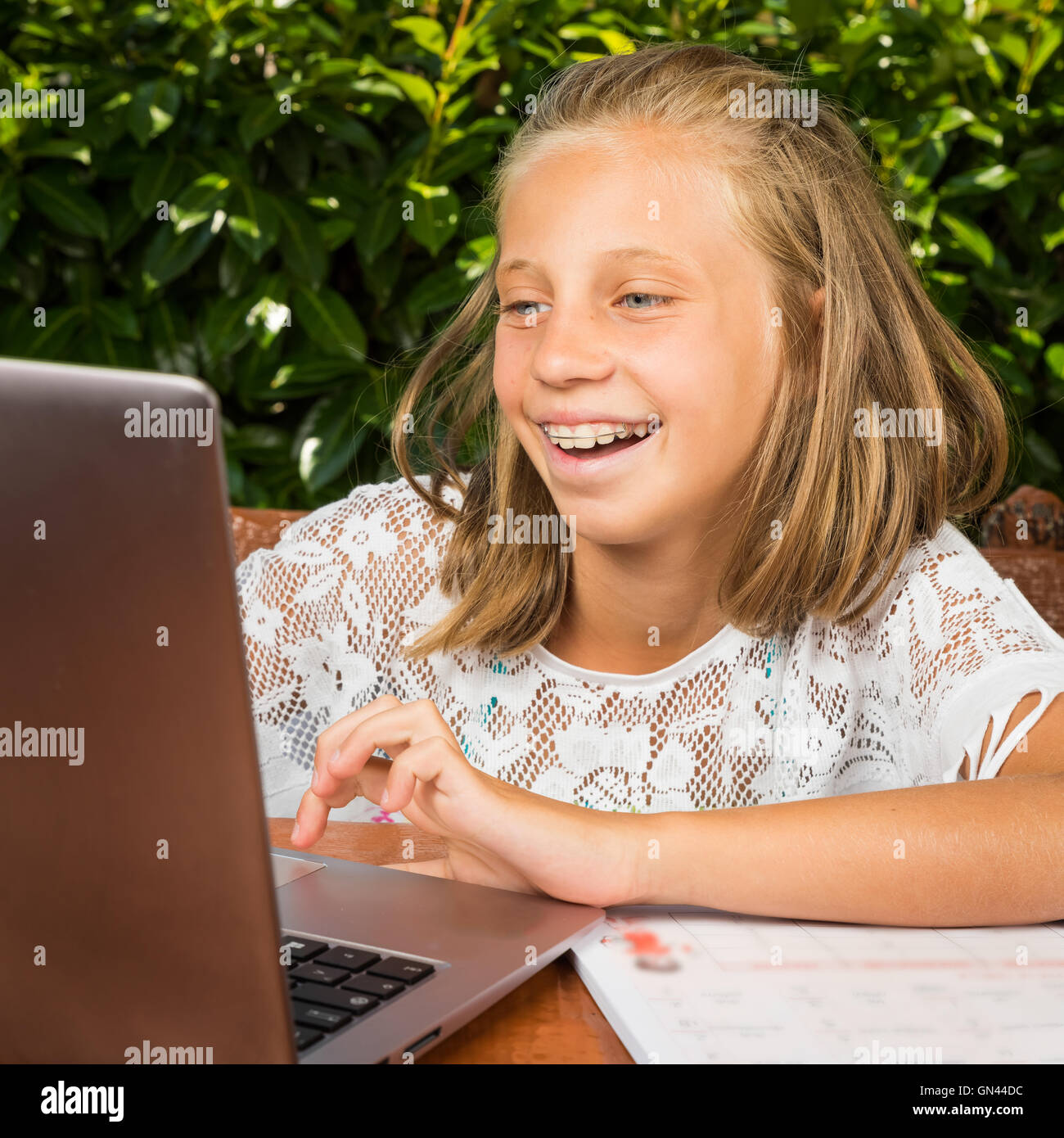 Beautiful teenager student,10 years old, have good news on the computer ...