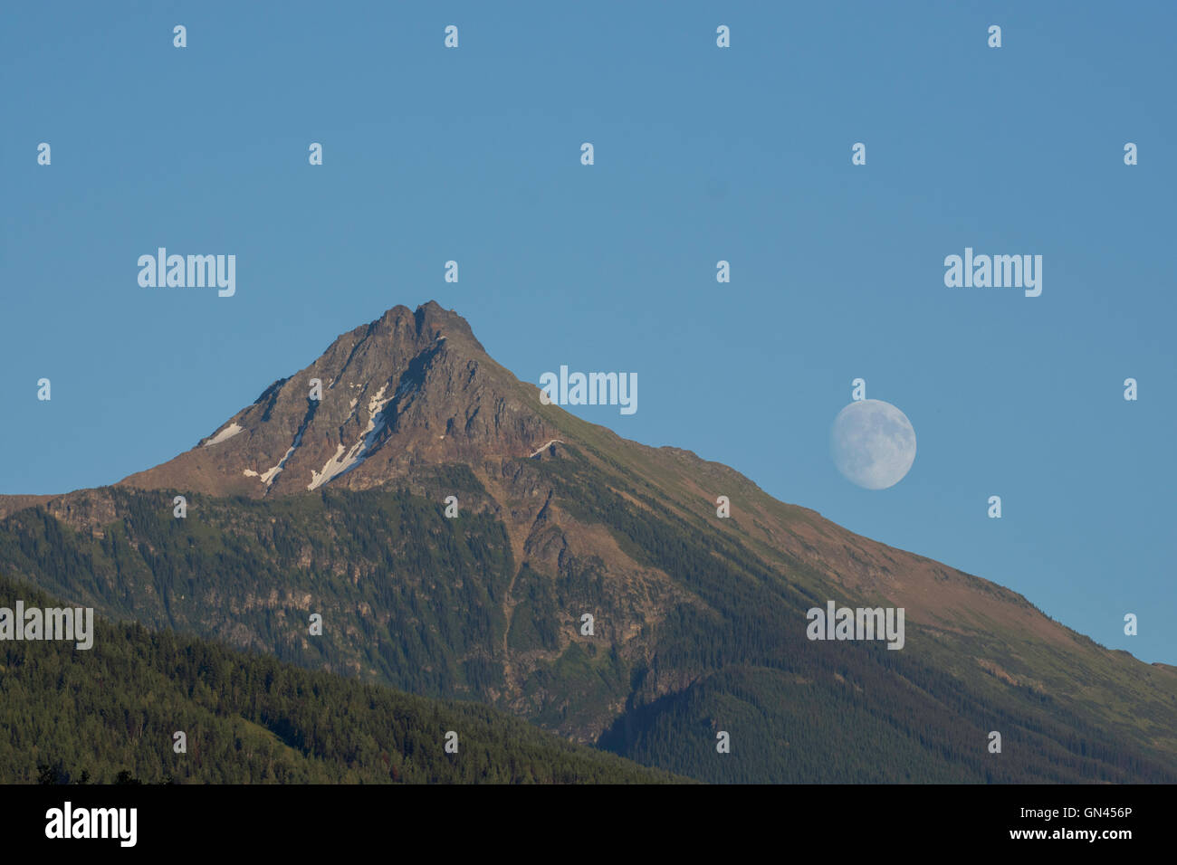 Moon over the mountain Stock Photo - Alamy
