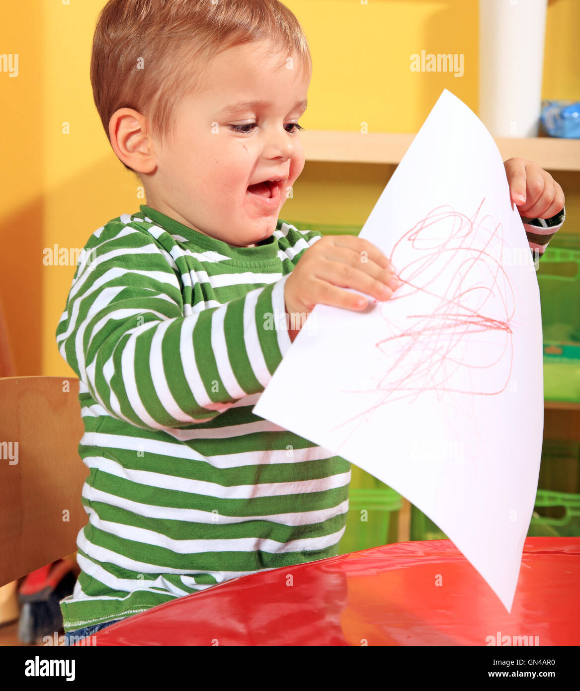 Toddler showing his picture Stock Photo - Alamy