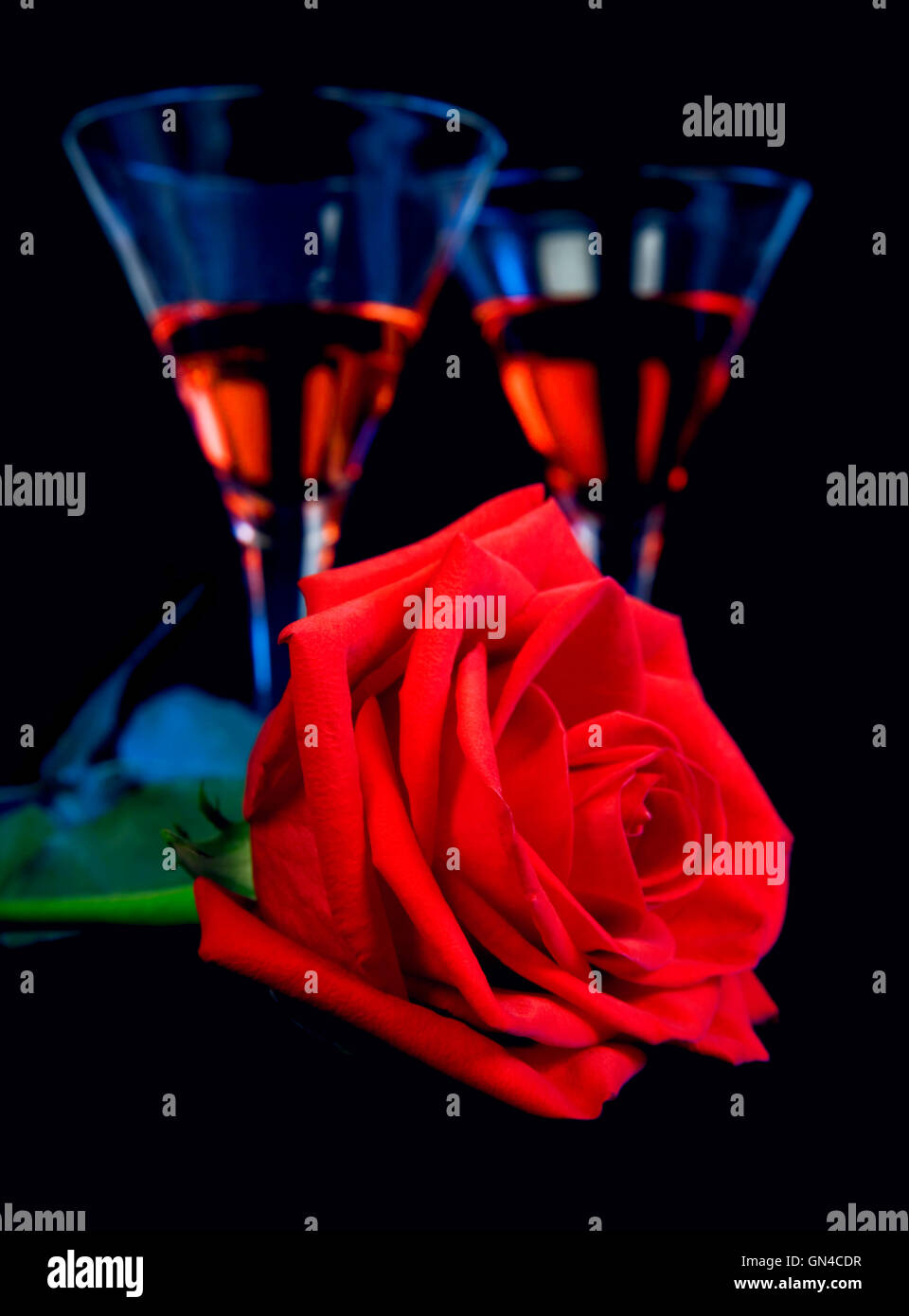 Gentle red rose and liquor in a glasses Stock Photo - Alamy