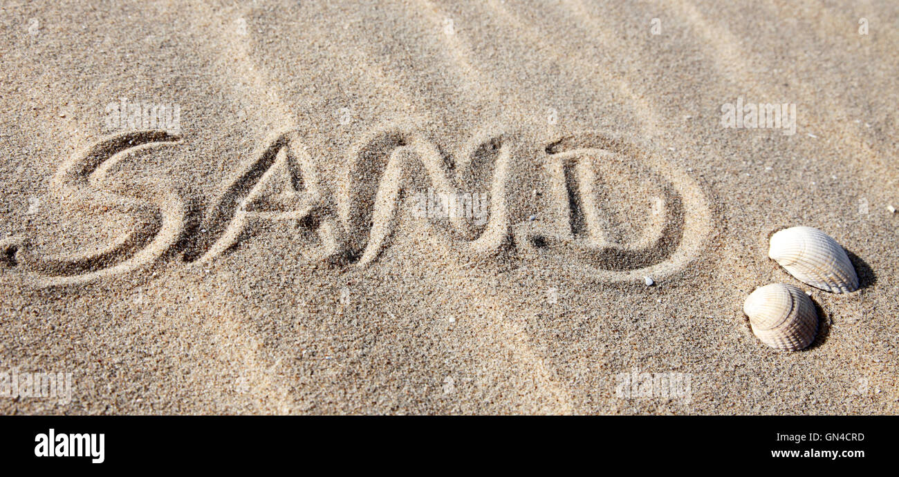 Sand written on the beach Stock Photo - Alamy