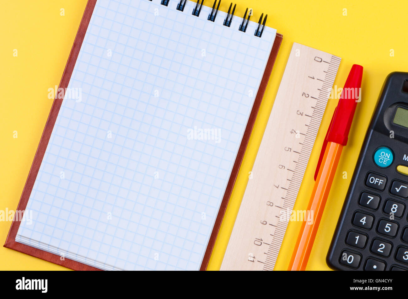 Stationery on yellow background Stock Photo - Alamy