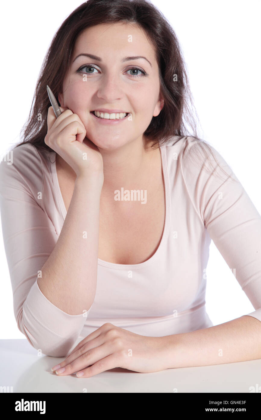 Young woman sitting at a desk Stock Photo - Alamy
