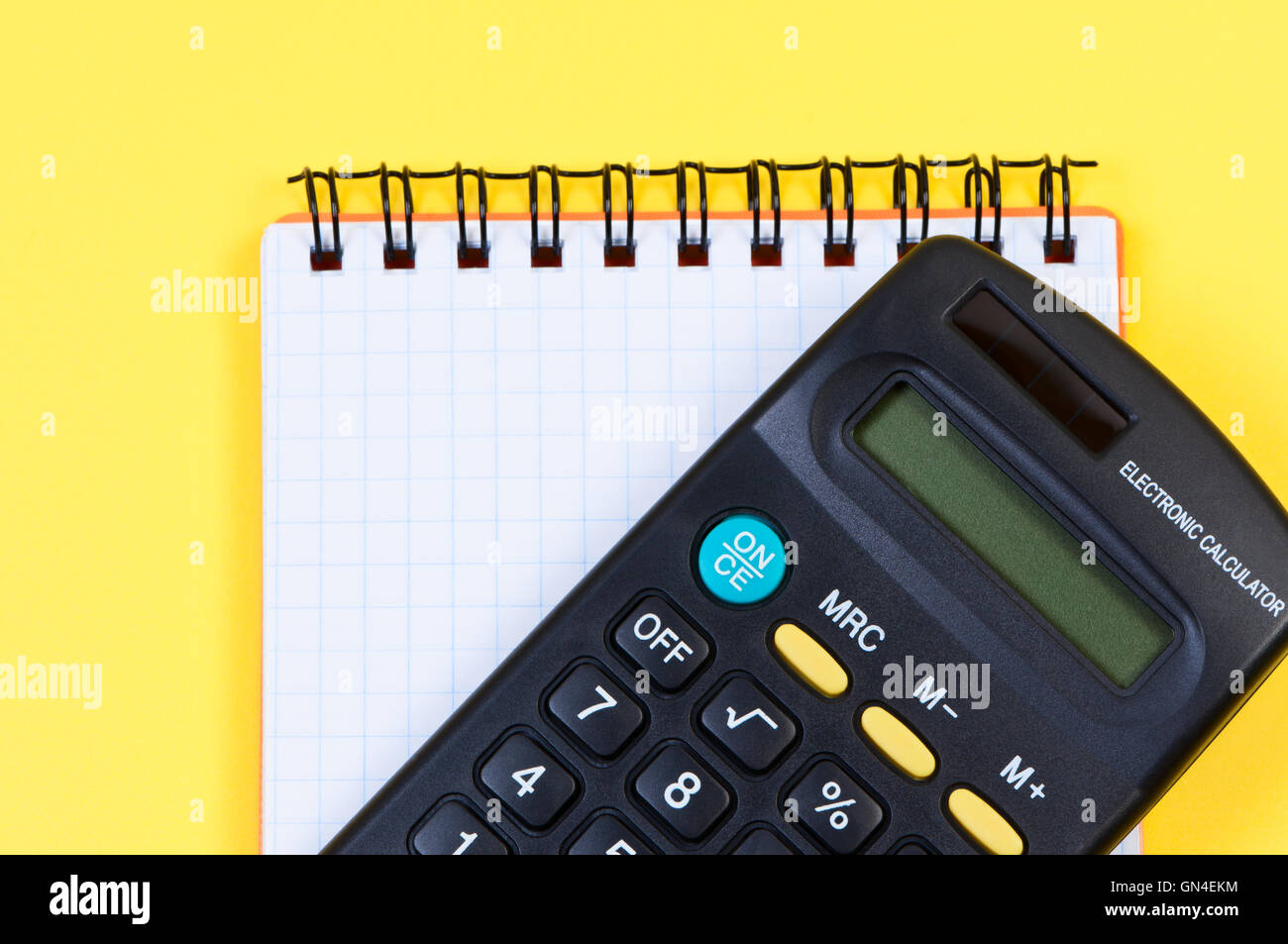 Calculator and notepad close-up view above Stock Photo - Alamy