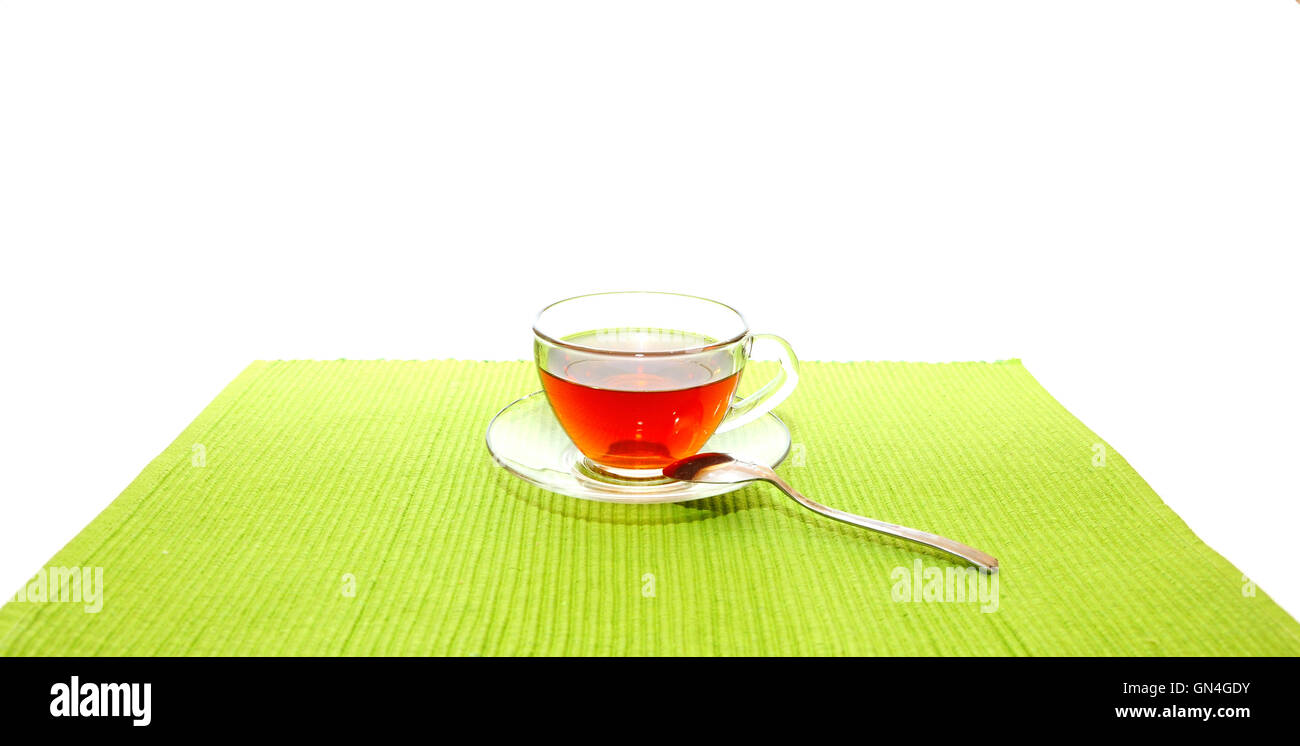 the cup of tea with spoon on the green napkin Stock Photo - Alamy