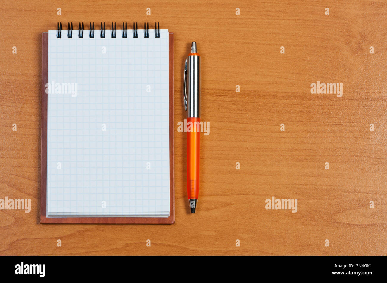 Notebook and ballpen on table Stock Photo - Alamy