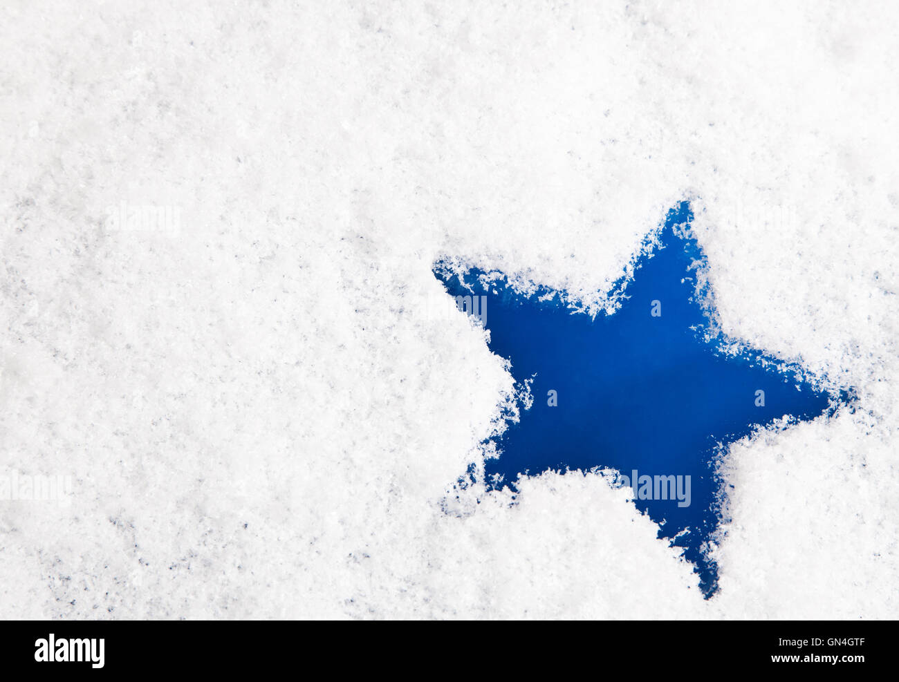 Blue star in snow Stock Photo - Alamy