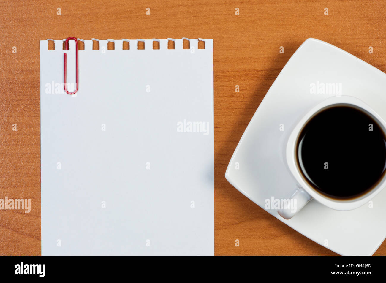 Torn sheet of paper and cup coffee on table Stock Photo - Alamy