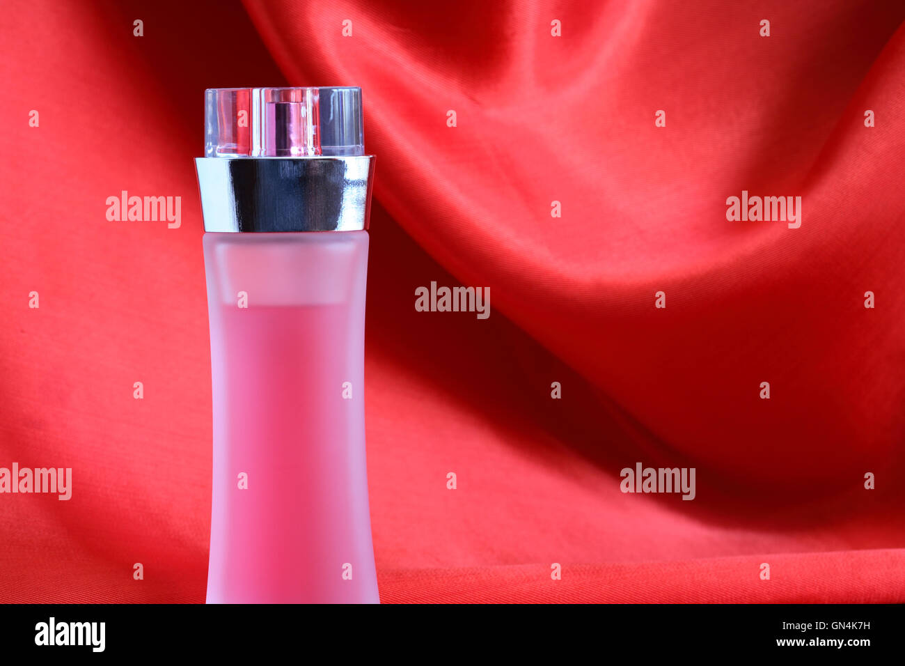 Perfume On Red Stock Photo - Alamy