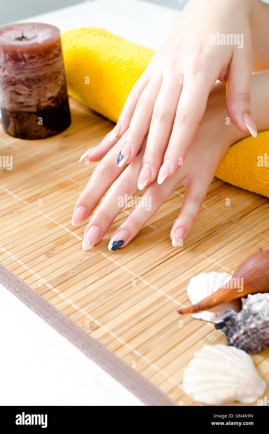 Spa hands over bamboo mat Stock Photo - Alamy