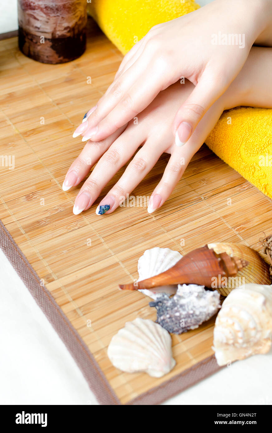Spa hands over bamboo mat Stock Photo - Alamy