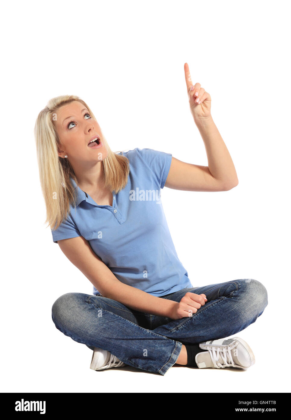 Attractive woman pointing above Stock Photo - Alamy