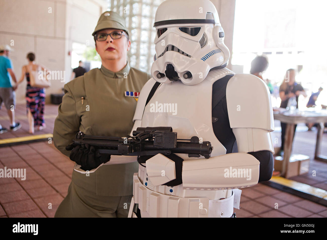 Female Imperial officer and Stormtrooper holding E-11 blaster rifle ...