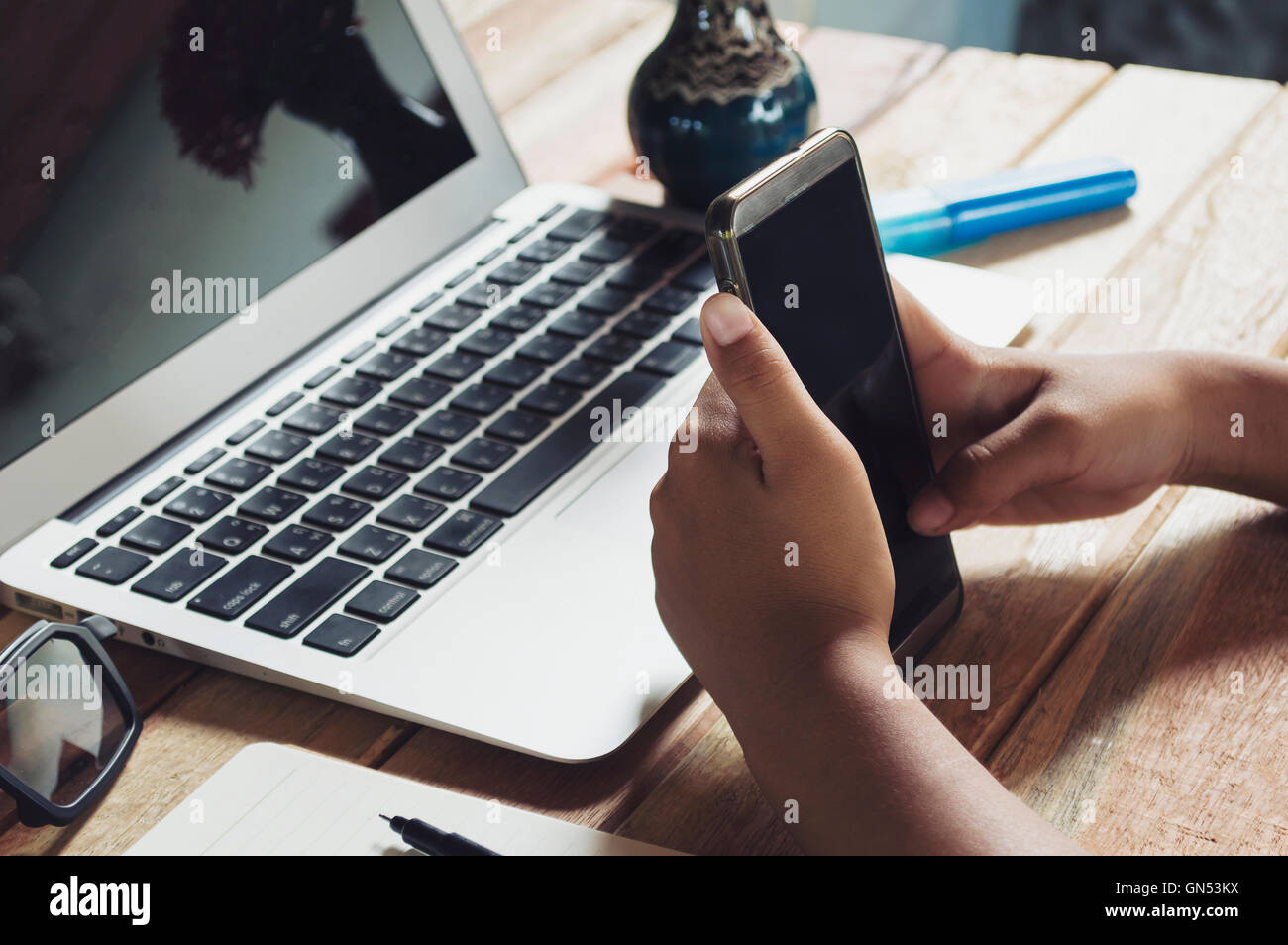 Kids doing homework by Internet with laptop,phone,notepad on wooden ...