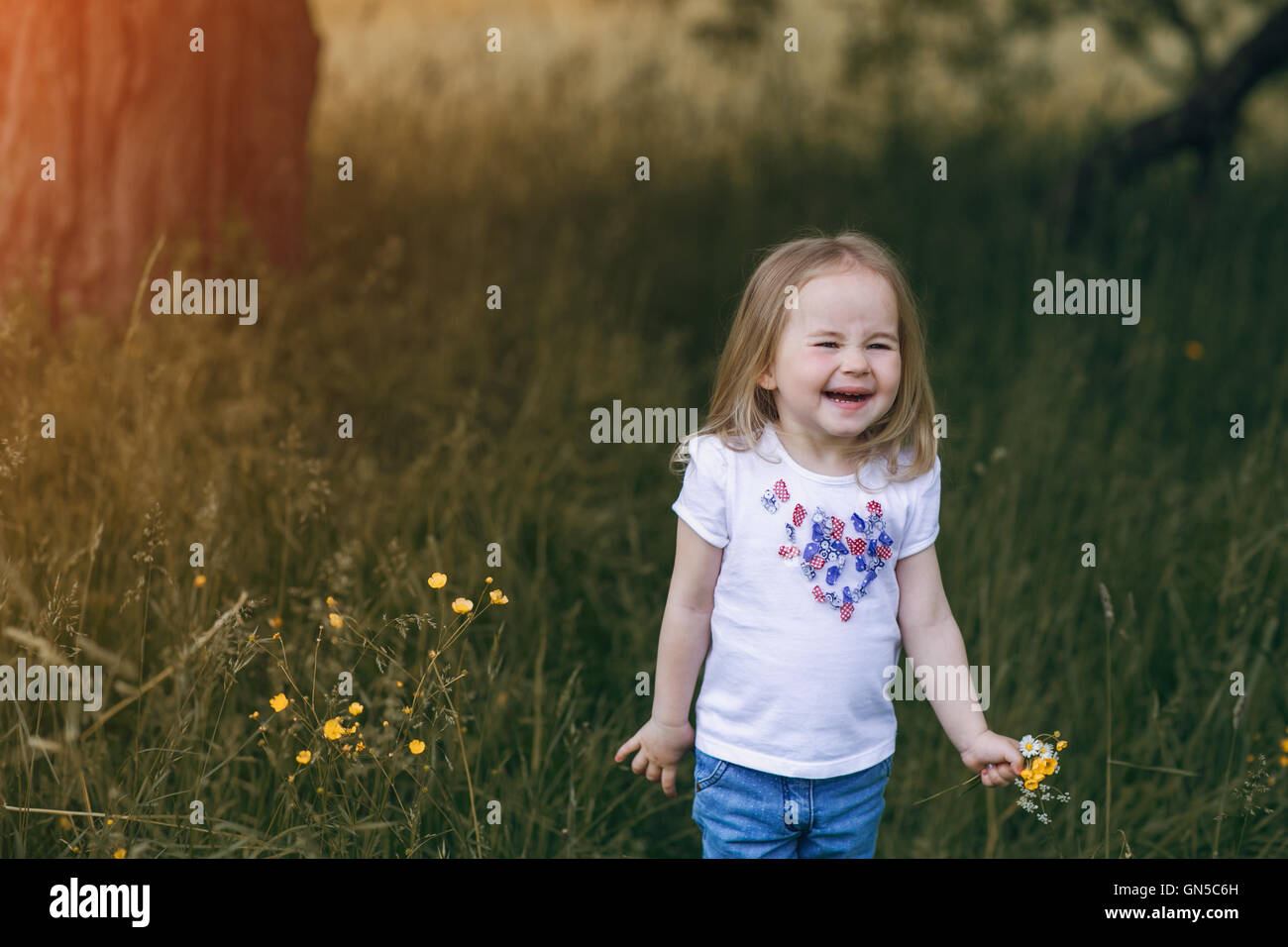 child near tree Stock Photo - Alamy