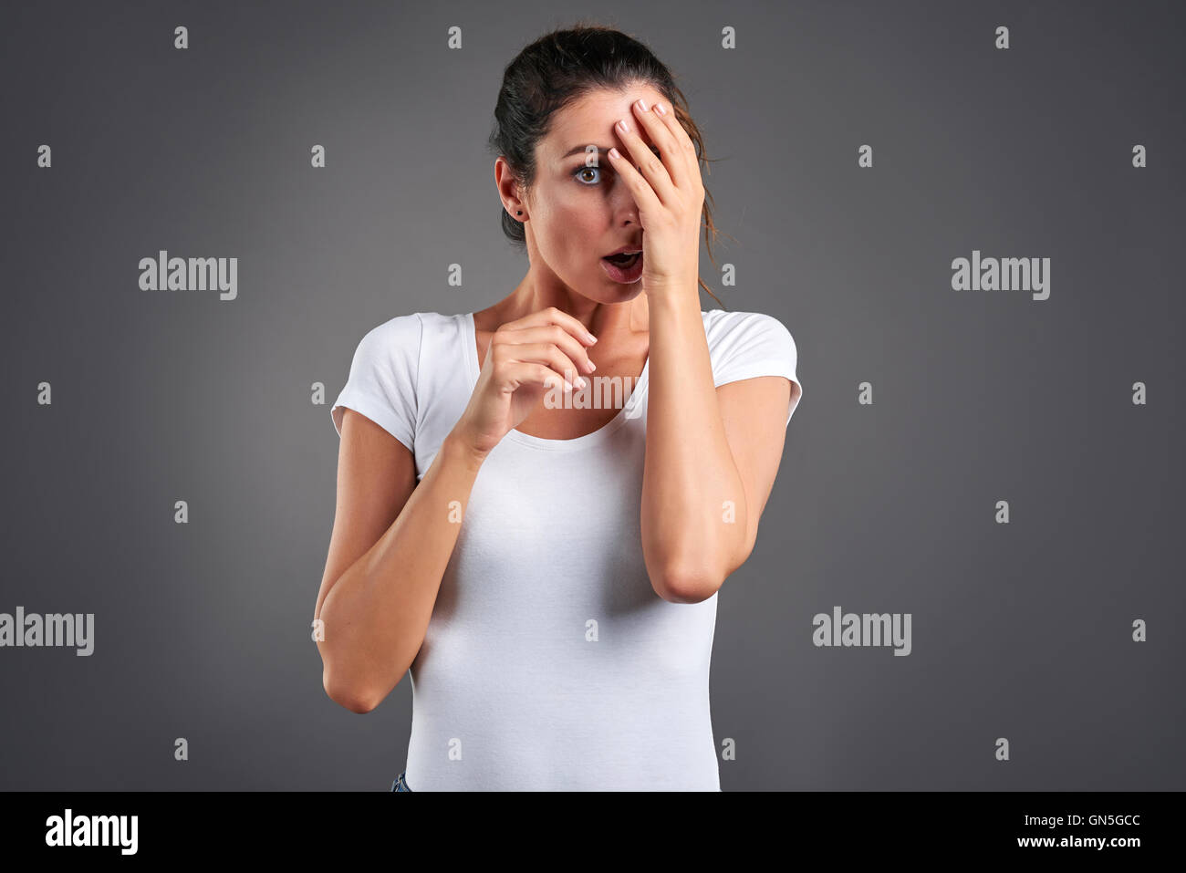 A beautiful young woman feeling scared Stock Photo - Alamy