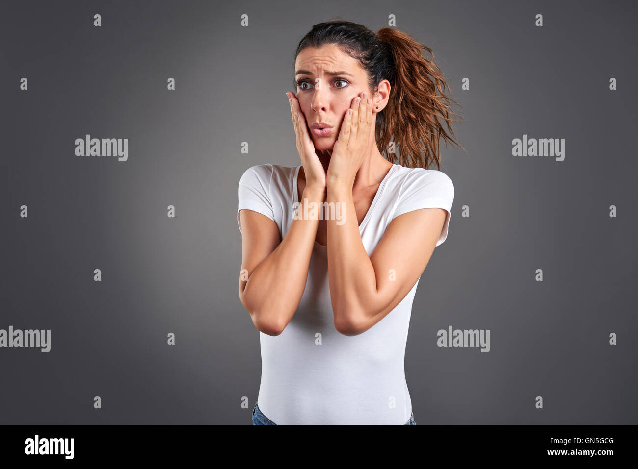 A beautiful young woman feeling scared Stock Photo - Alamy