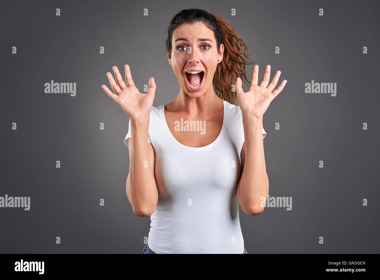 A beautiful young woman feeling scared Stock Photo - Alamy