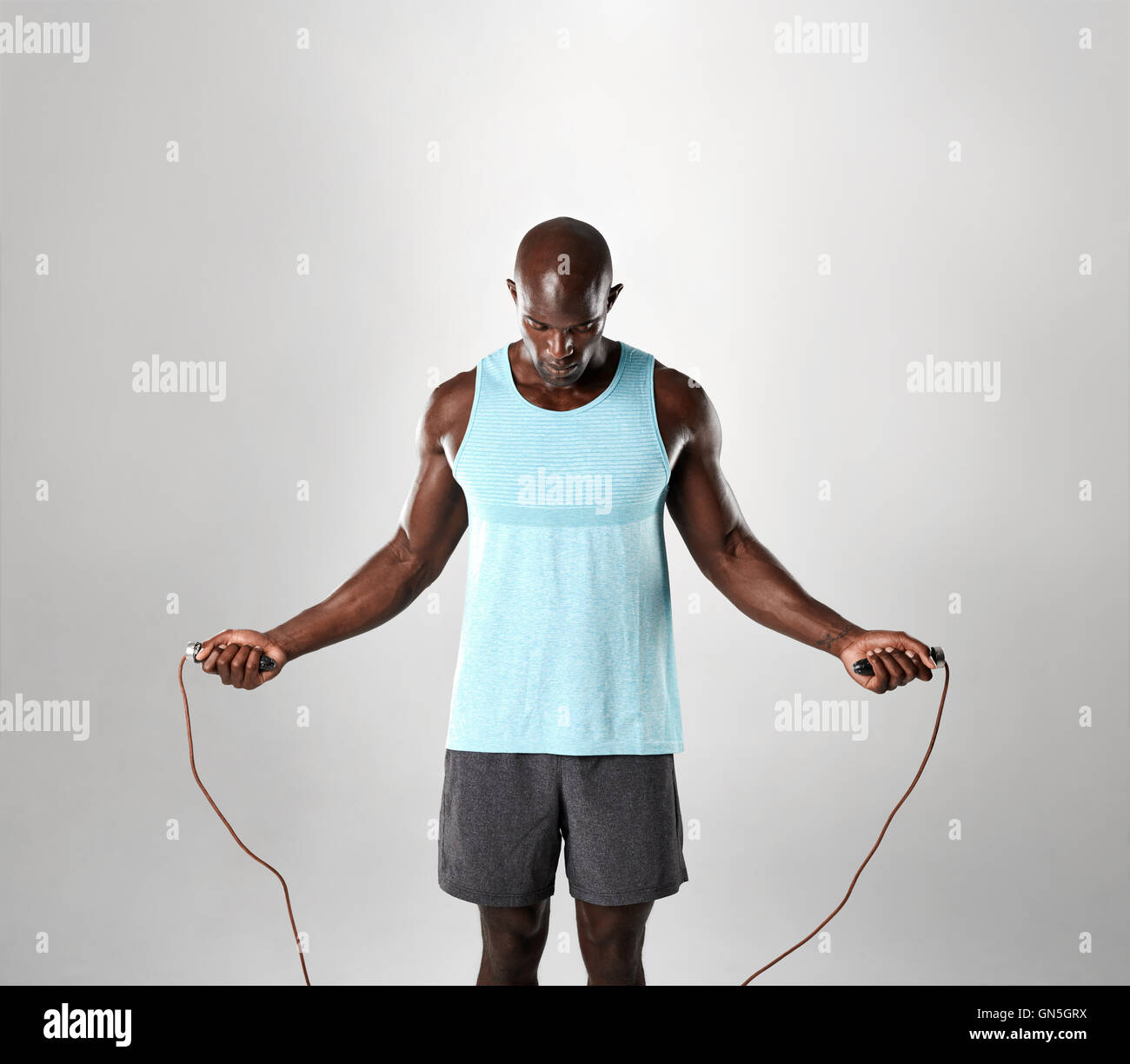 Portrait Of Masculine Man Skipping Rope Muscular Young Man Exercising With Jumping Rope Against