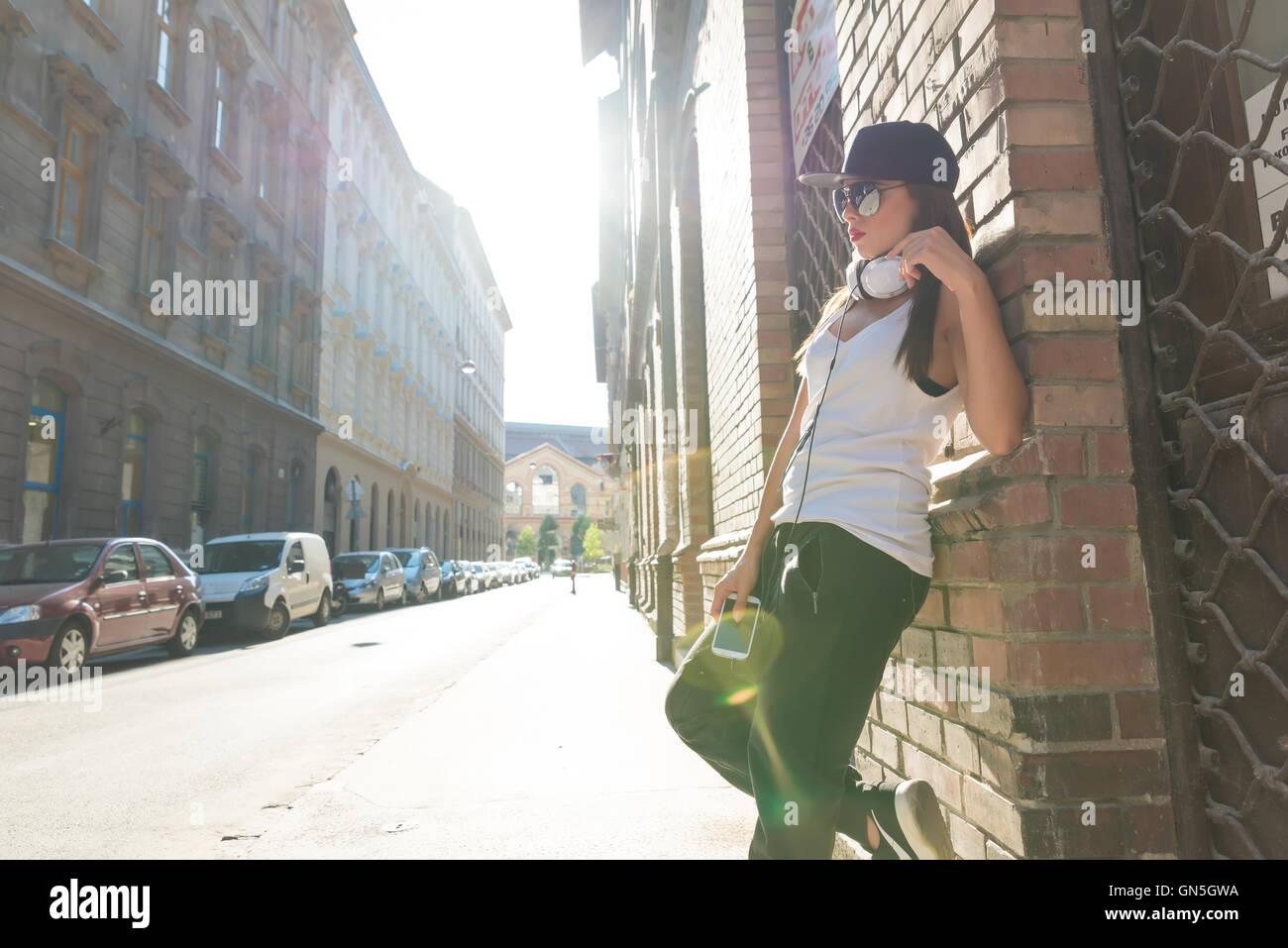A beautiful young Hip Hop Rapper girl with Headphones in a urban ...