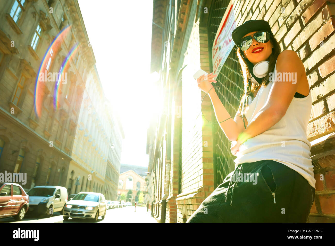 A beautiful young Hip Hop Rapper girl with Headphones in a urban ...