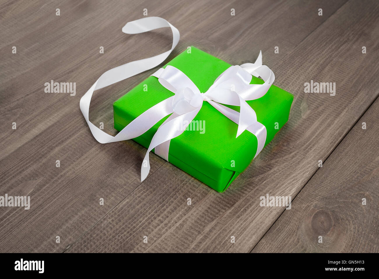 surprise in red packing on a wooden background Stock Photo - Alamy