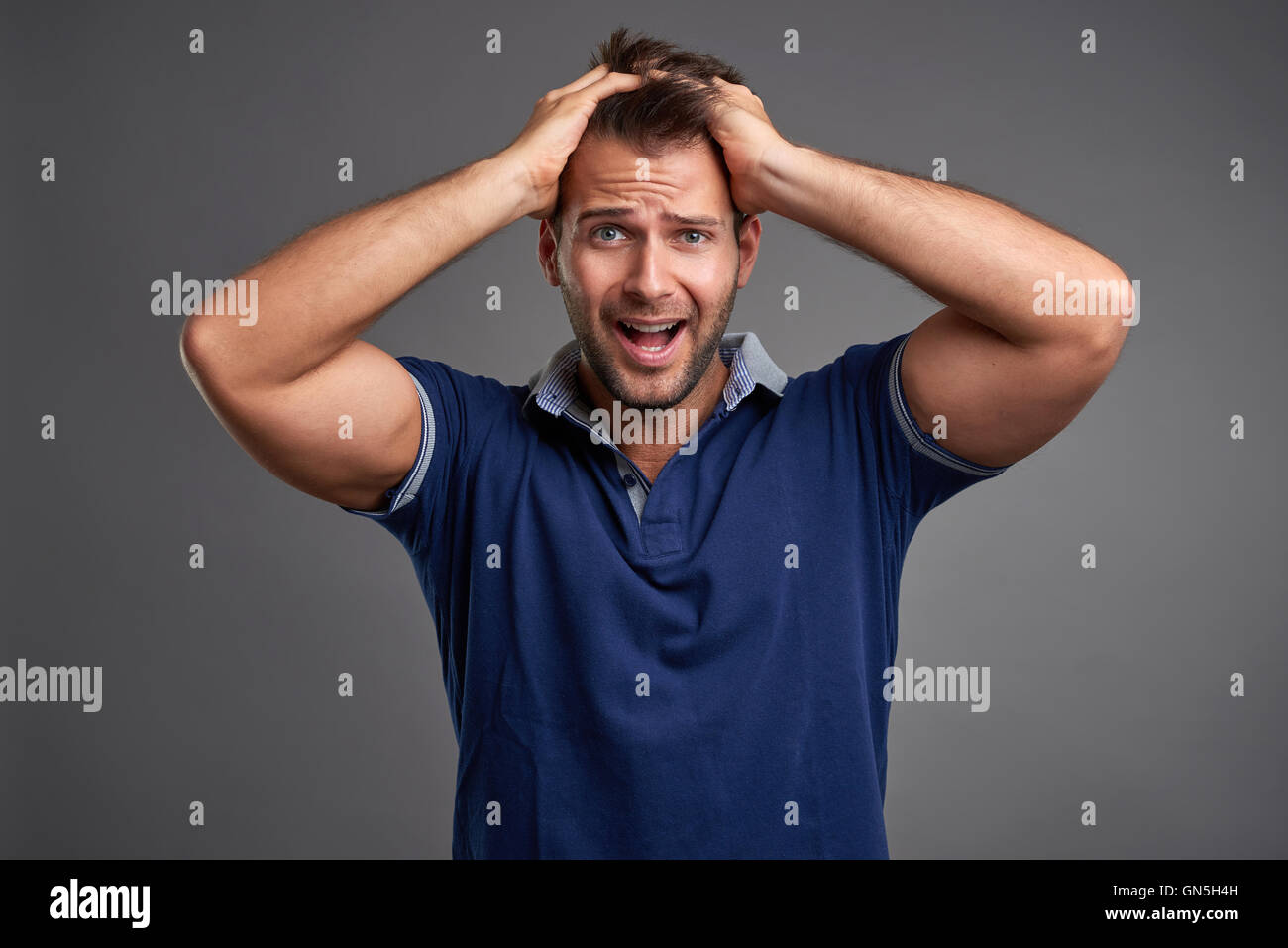 A handsome young man feeling shocked and screaming Stock Photo - Alamy