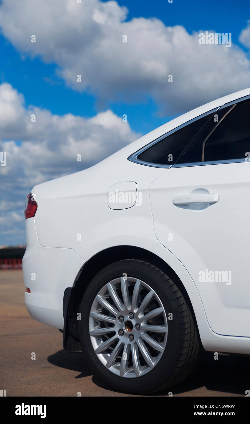 white modern car against the blue sky with clouds Stock Photo - Alamy