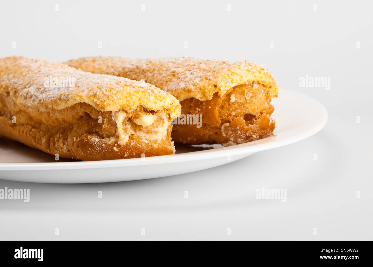 White plate eclairs butter cream hi-res stock photography and images ...