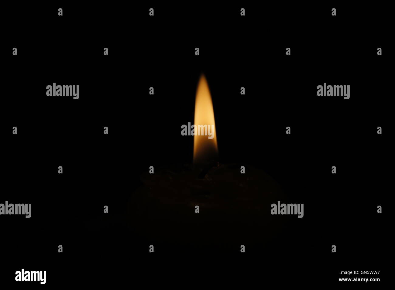 Candle flame burns in yellow hi-res stock photography and images - Alamy