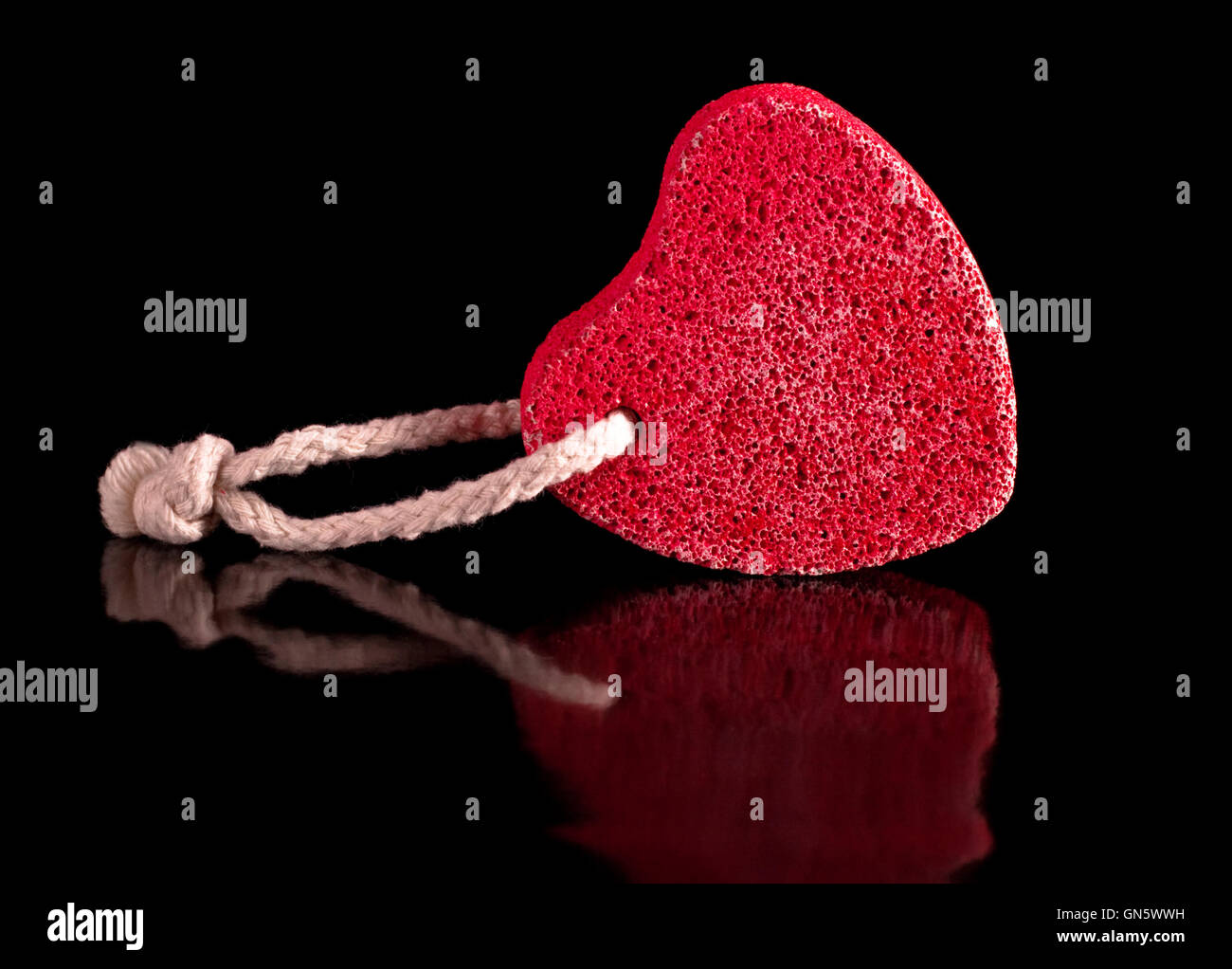 red heart-shaped stone with rope Stock Photo - Alamy