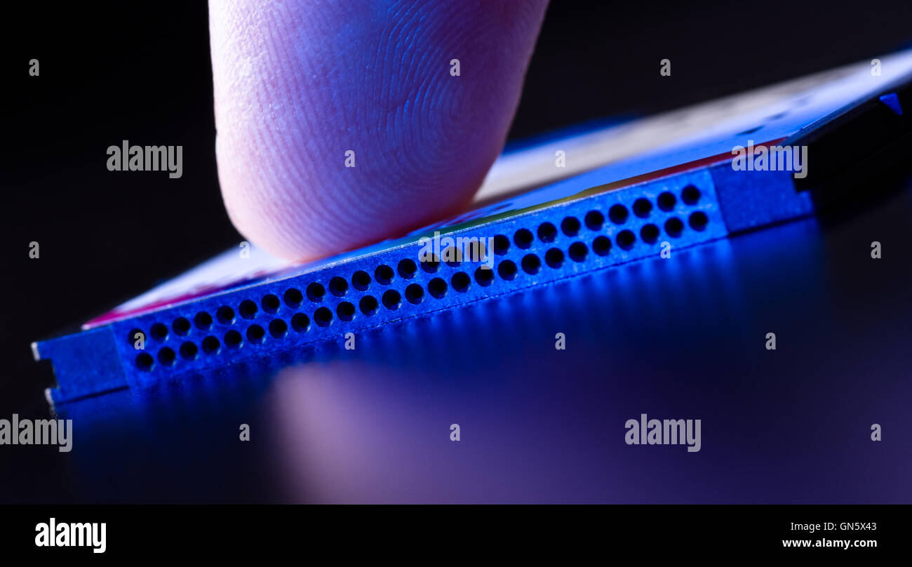 finger on flash card in blue light closeup Stock Photo - Alamy