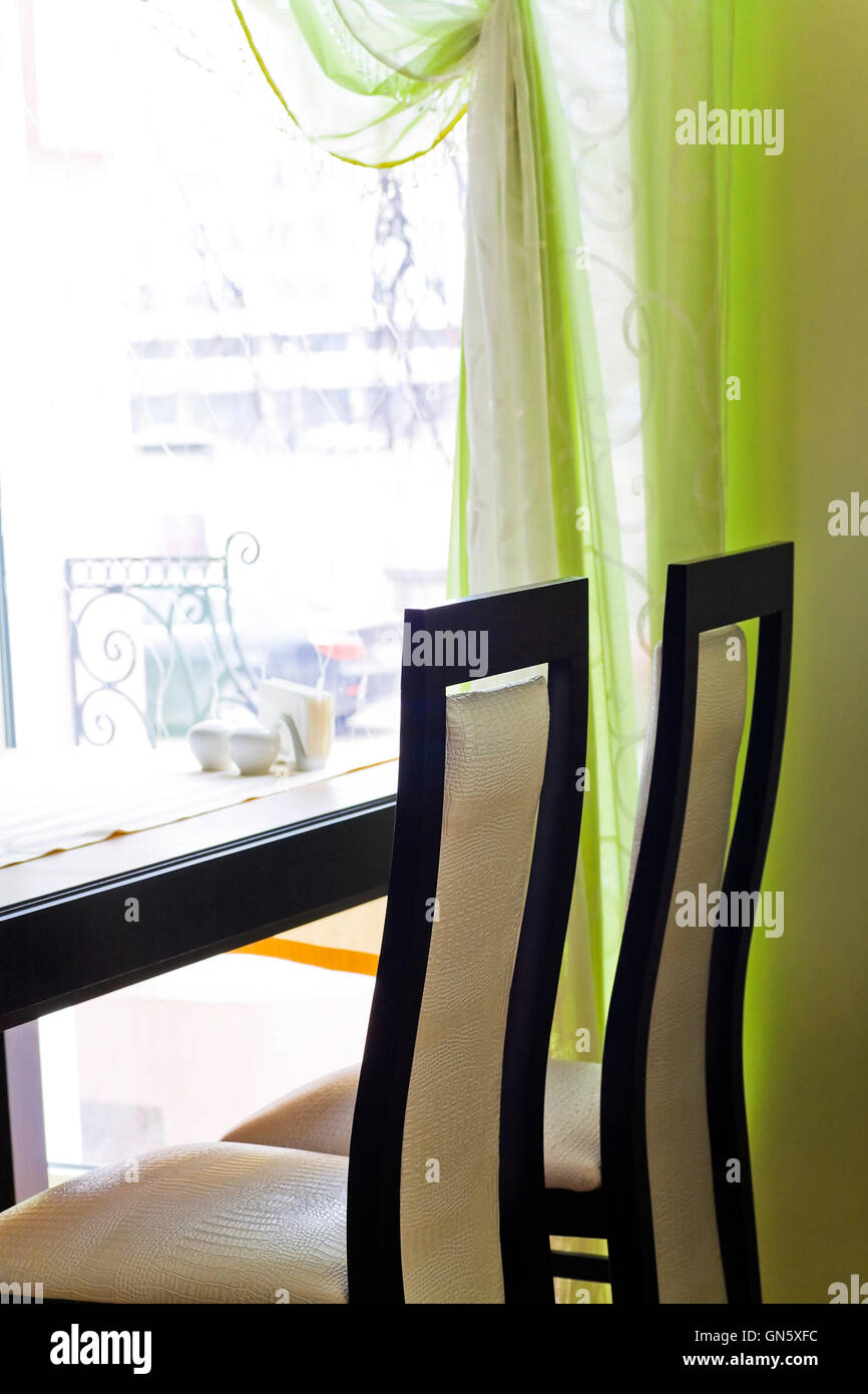 Two white chairs standing up for a table Stock Photo - Alamy