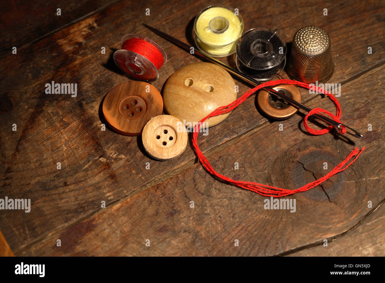 Needle And Buttons Stock Photo - Alamy