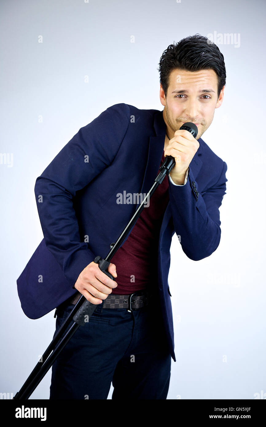 Man singing into microphone laughing Stock Photo - Alamy