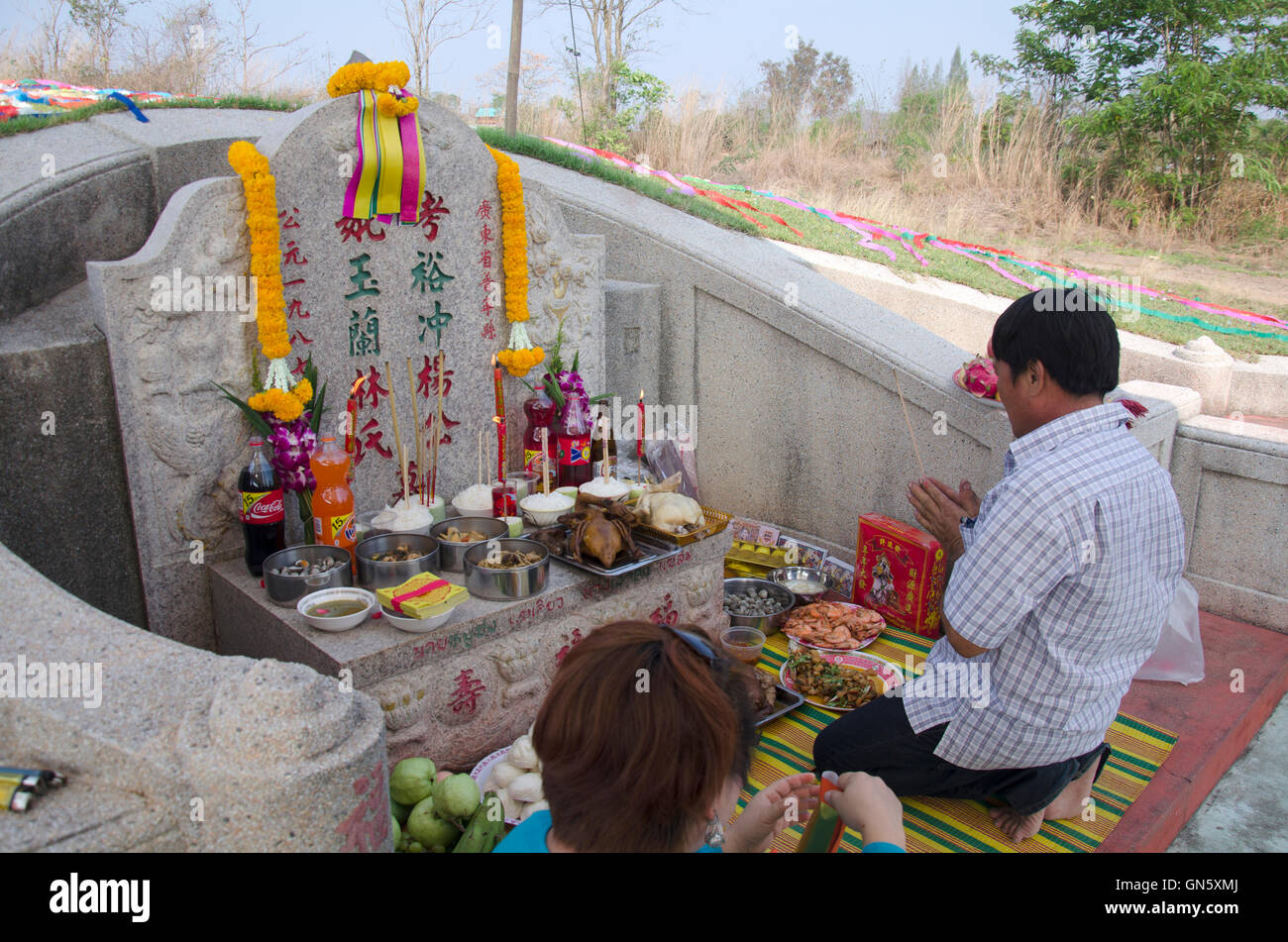 My family praying and sacrificial offering food and joss paper to ...