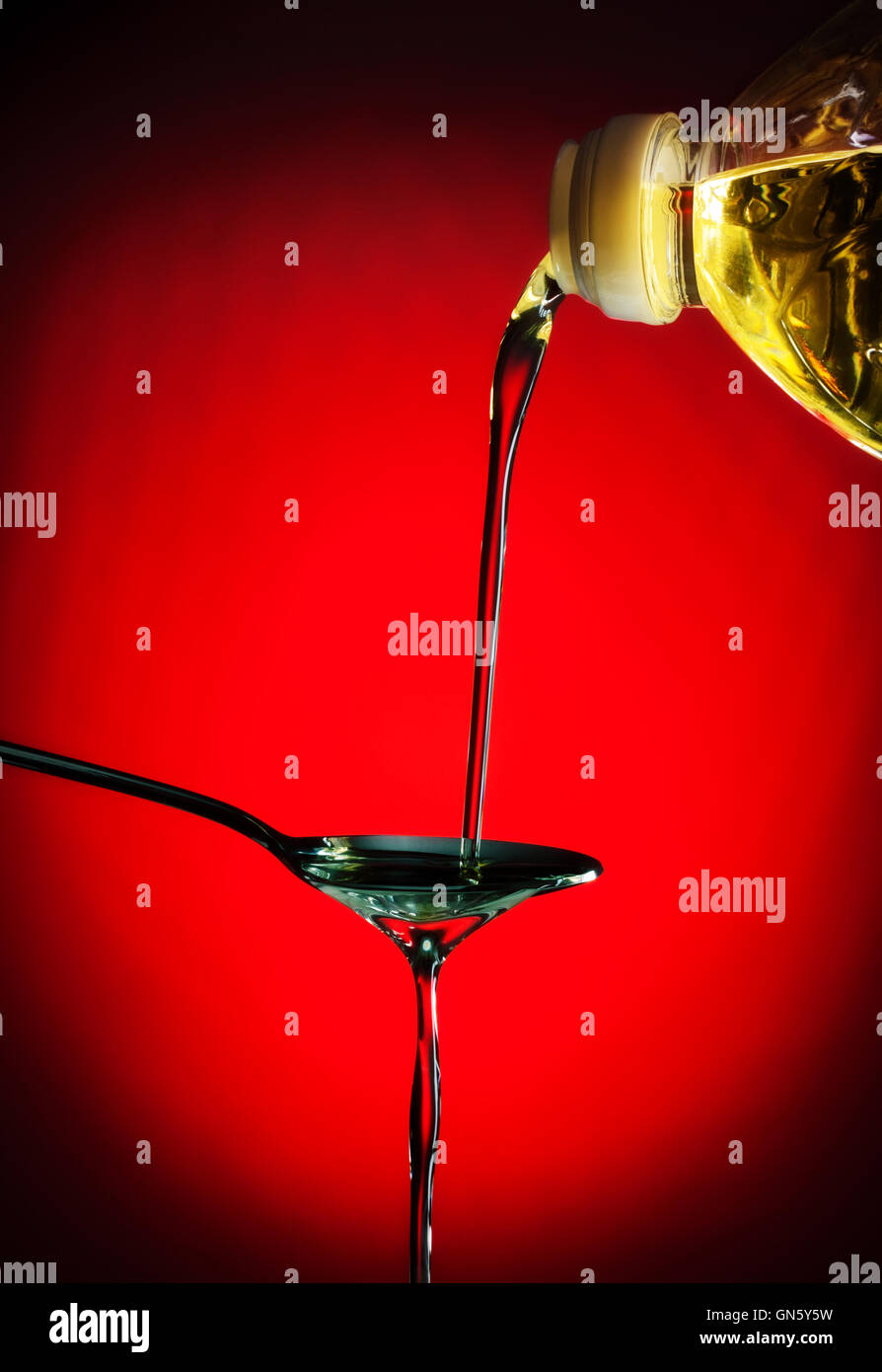 pouring oil on spoon Stock Photo - Alamy