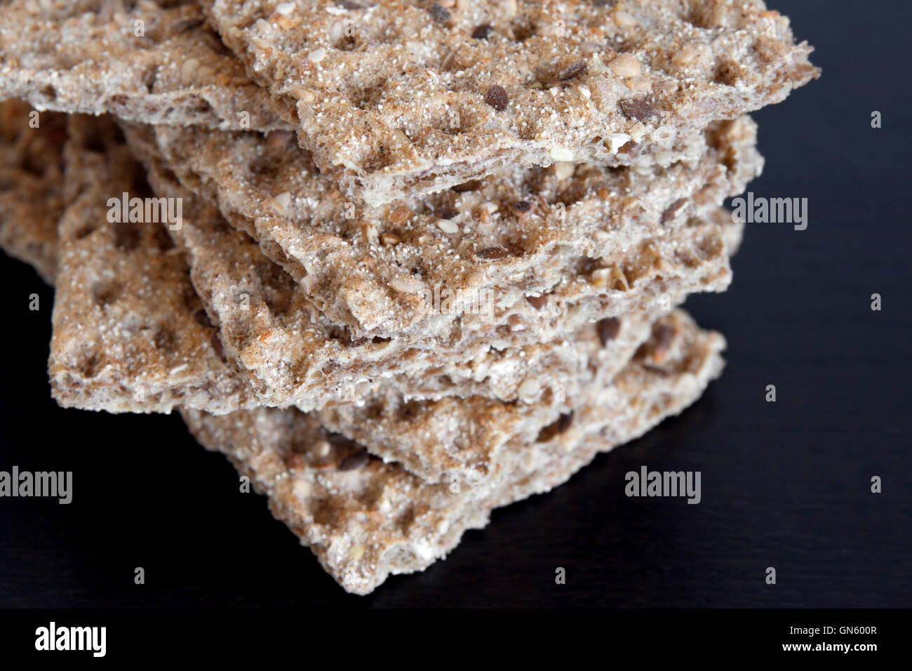 Multi-grain crisp bread on dark background Stock Photo - Alamy