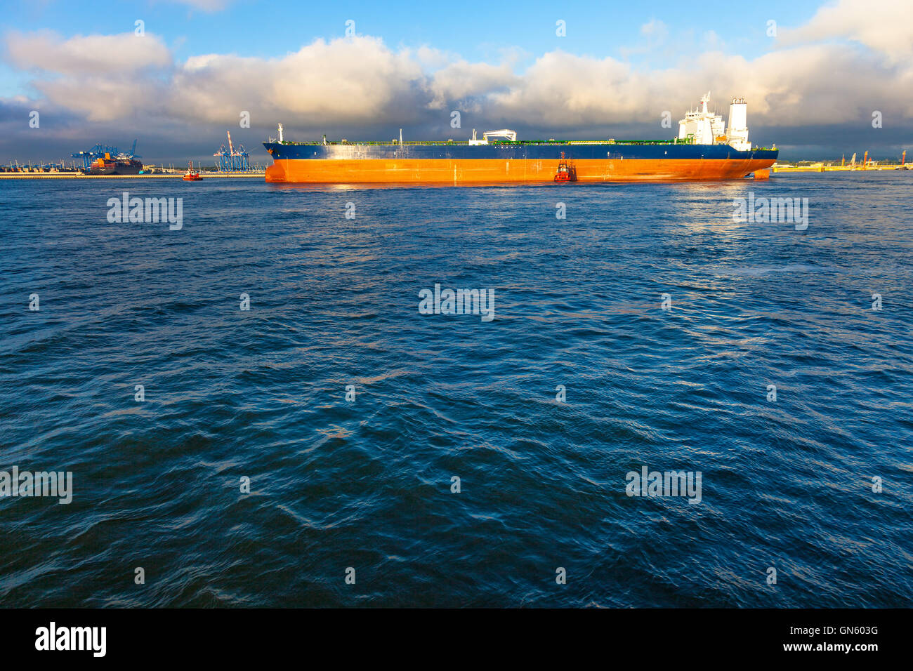 Tugboats pulling the tanker at sea in the morning Stock Photo - Alamy