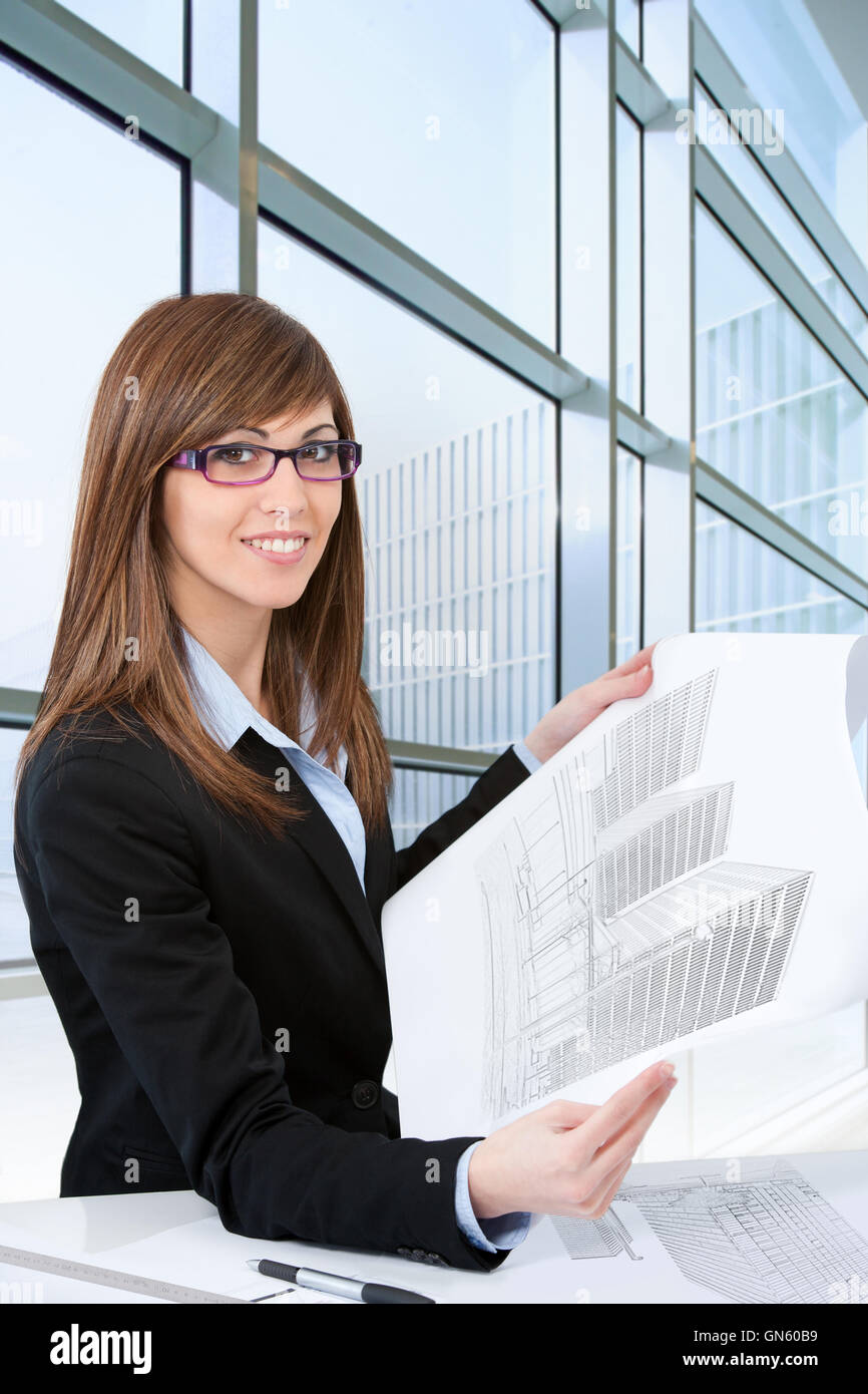 Portrait of young female architect with plans Stock Photo - Alamy