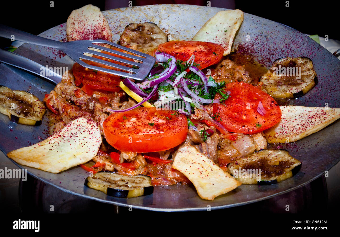 metal dish with fried meat and vegetables Stock Photo - Alamy