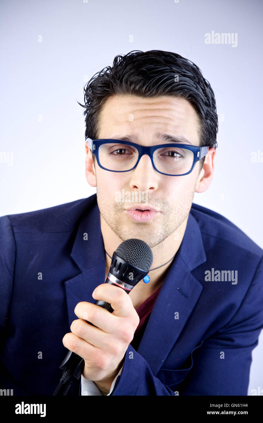 Man singing into microphone Stock Photo - Alamy