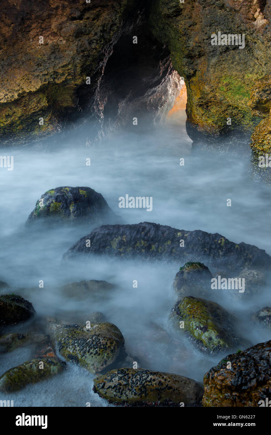 Small cave at sea shore background Stock Photo - Alamy