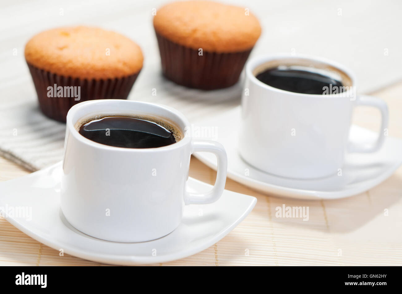 Two cups of coffee and cupcakes Stock Photo - Alamy