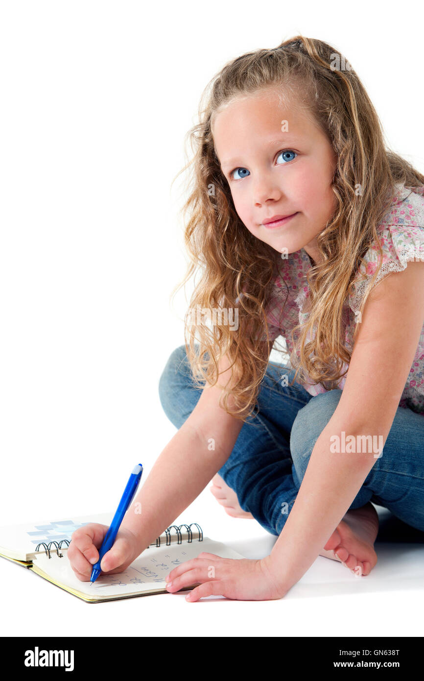 Cute girl doing homework isolated Stock Photo - Alamy