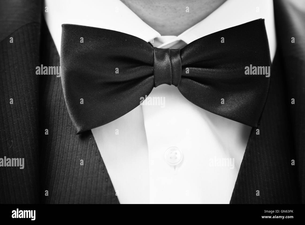 Black suit with white shirt and black bow tie hi-res stock photography ...