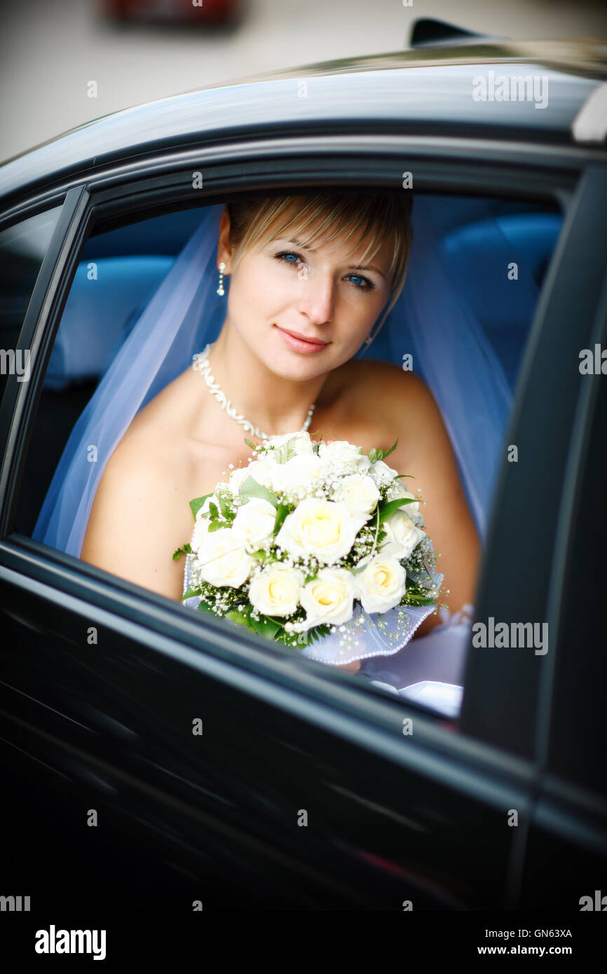 portrait of the bride in the wedding car Stock Photo - Alamy
