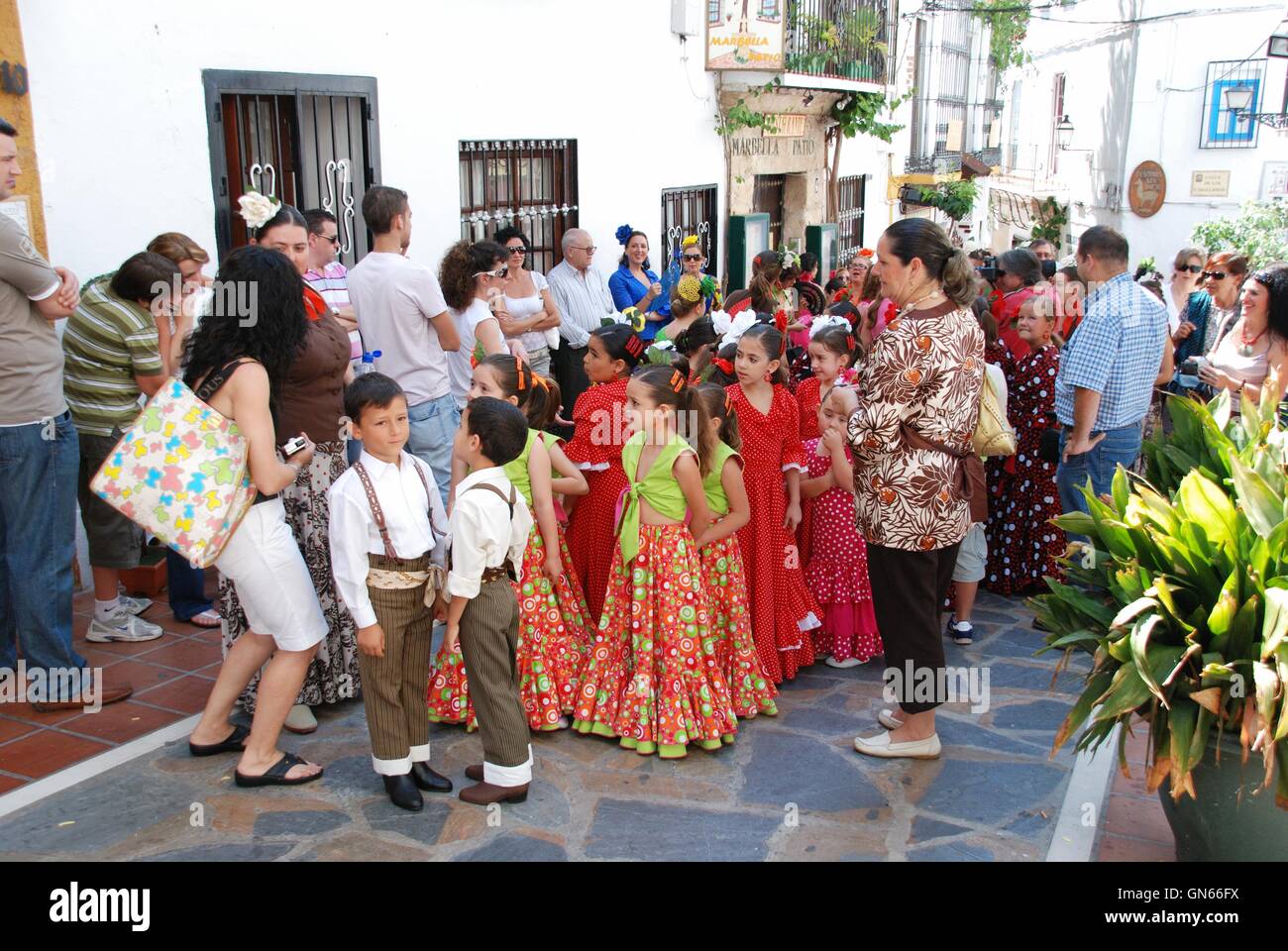 Spanish children in traditional dress standing in the street during the ...