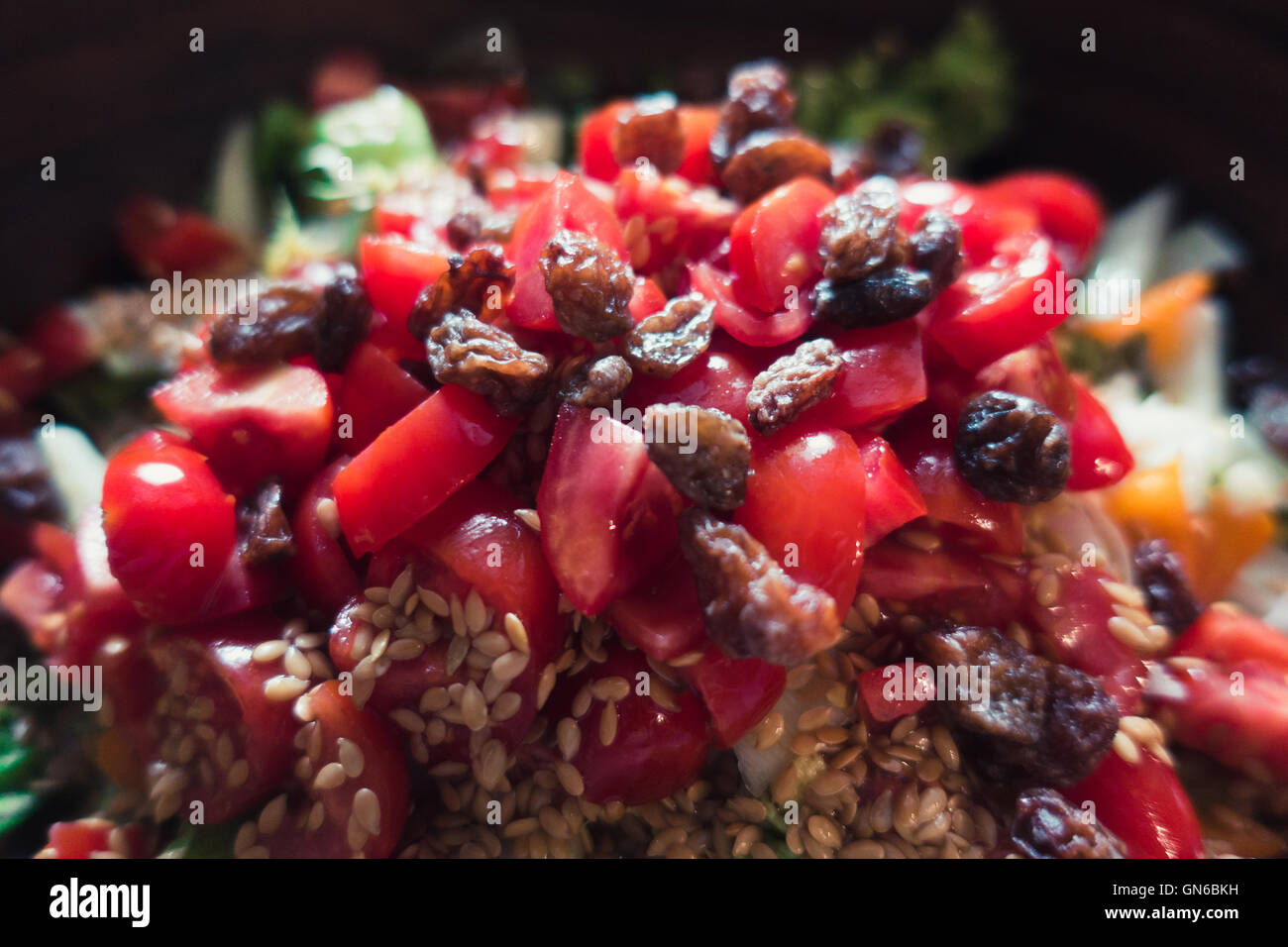 Summer salad with tomatoes seeds and sultana in a wood bowl Stock Photo ...
